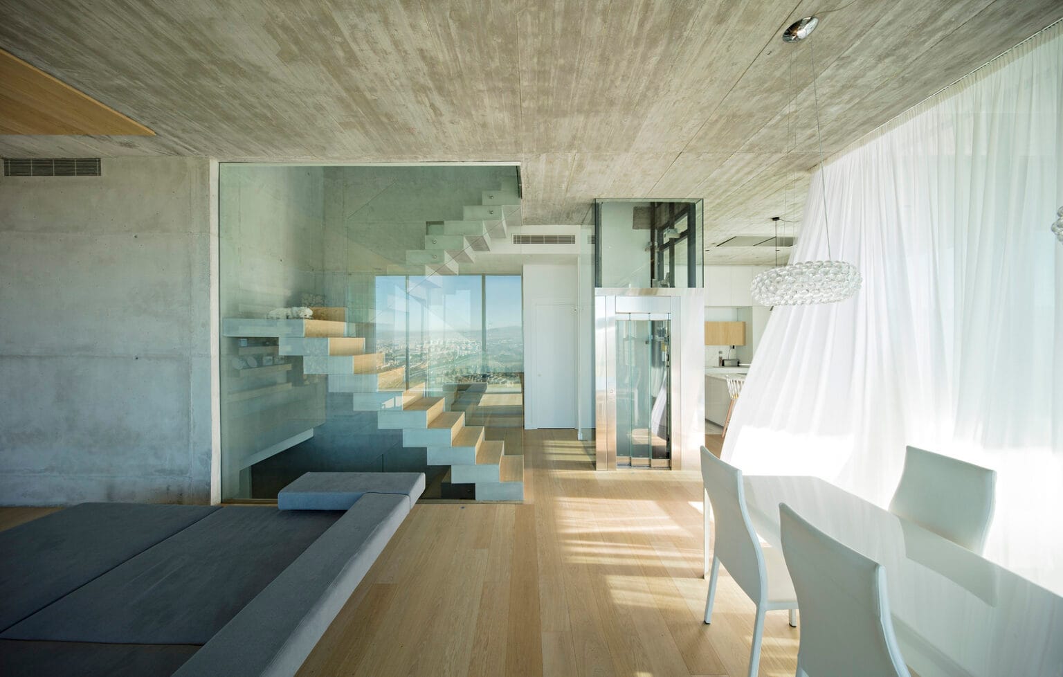 Concrete Walls Frame Panoramic Views in a Multi-Level Granada Home